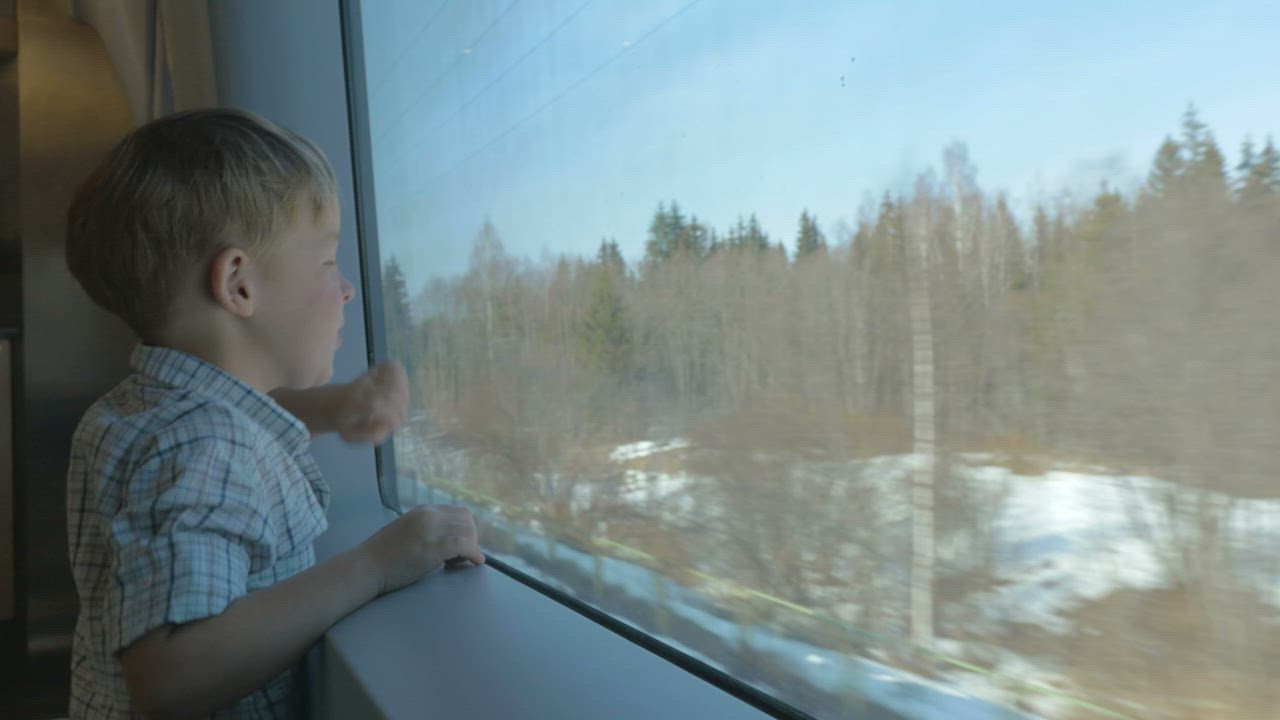 Boy looking out of a train window - Free Stock Video