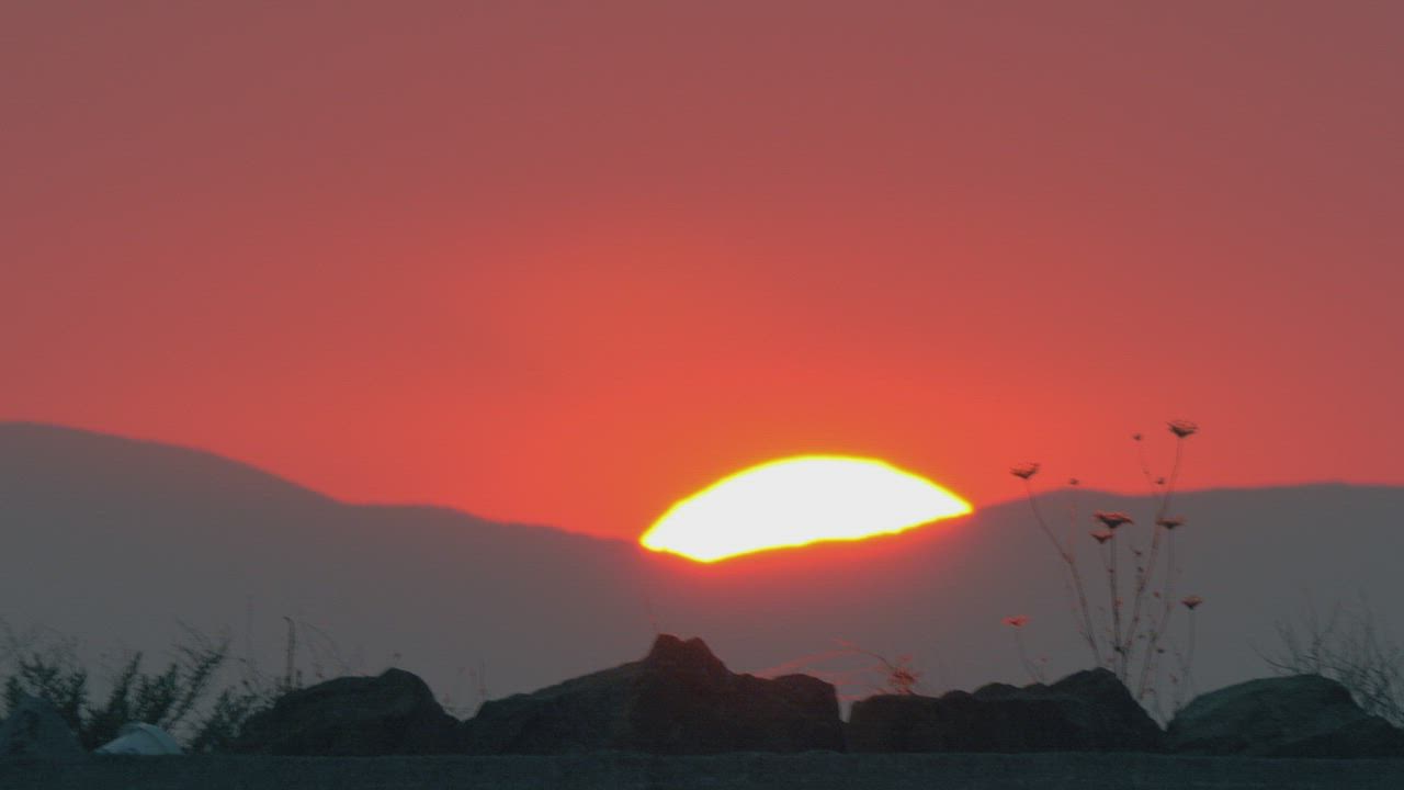 Sun going down behind mountains - Free Stock Video