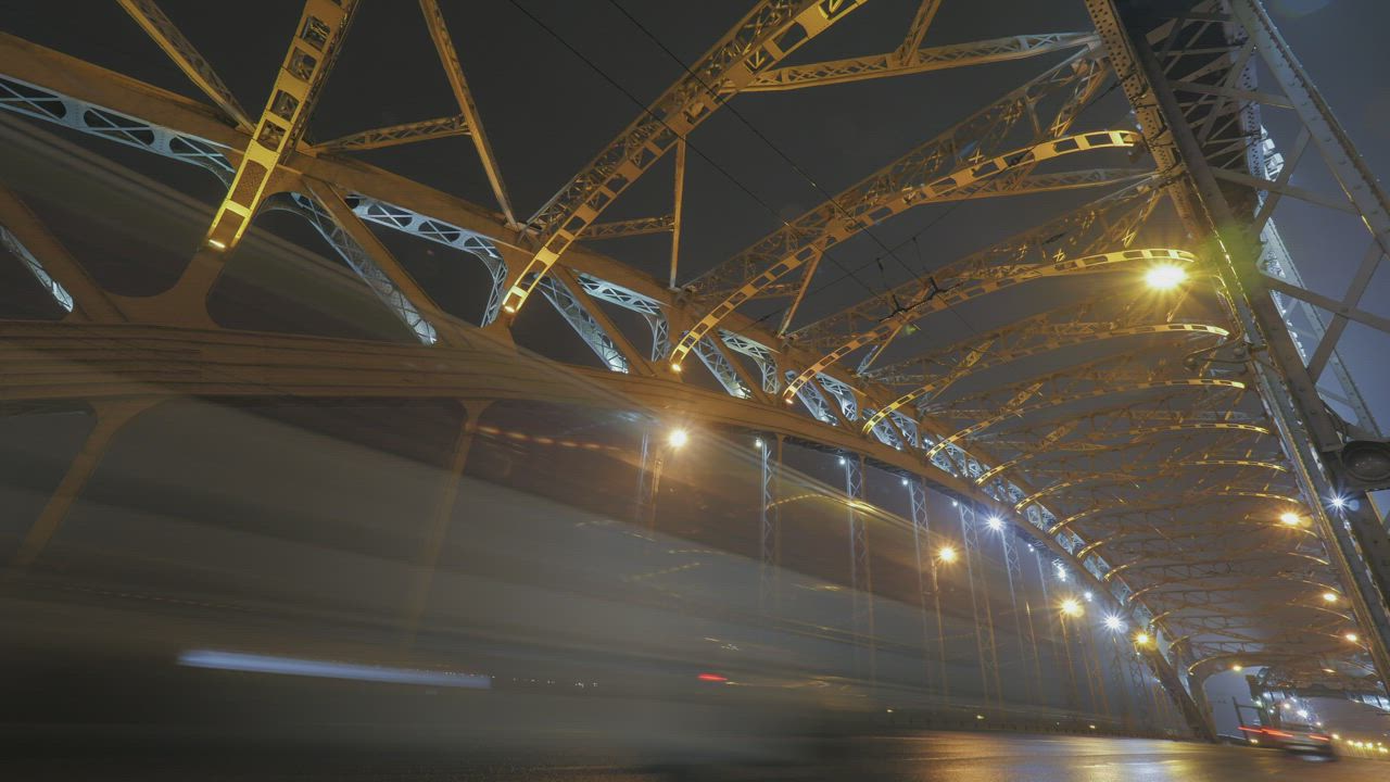 Night traffic heading over a tall bridge - Free Stock Video