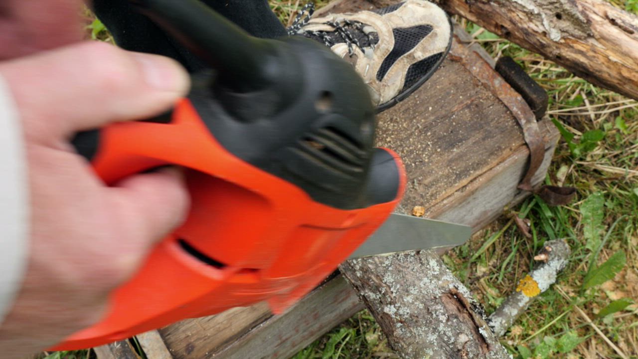 Man cutting up wood with an electric saw - Free Stock Video