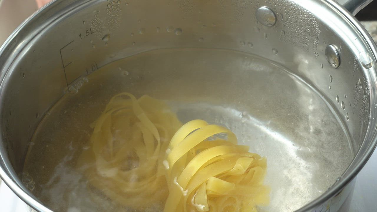 Boiling pasta in a large pan - Free Stock Video