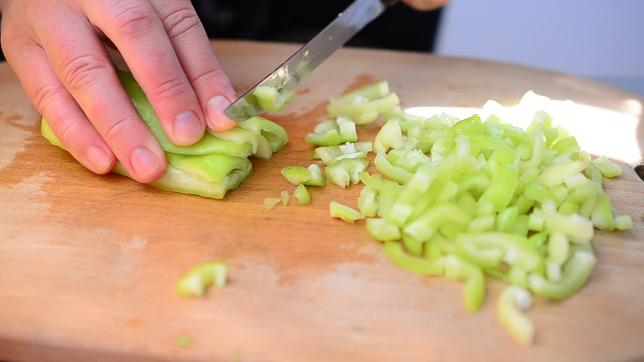 Cutting up a pepper in the kitchen - Free Stock Video