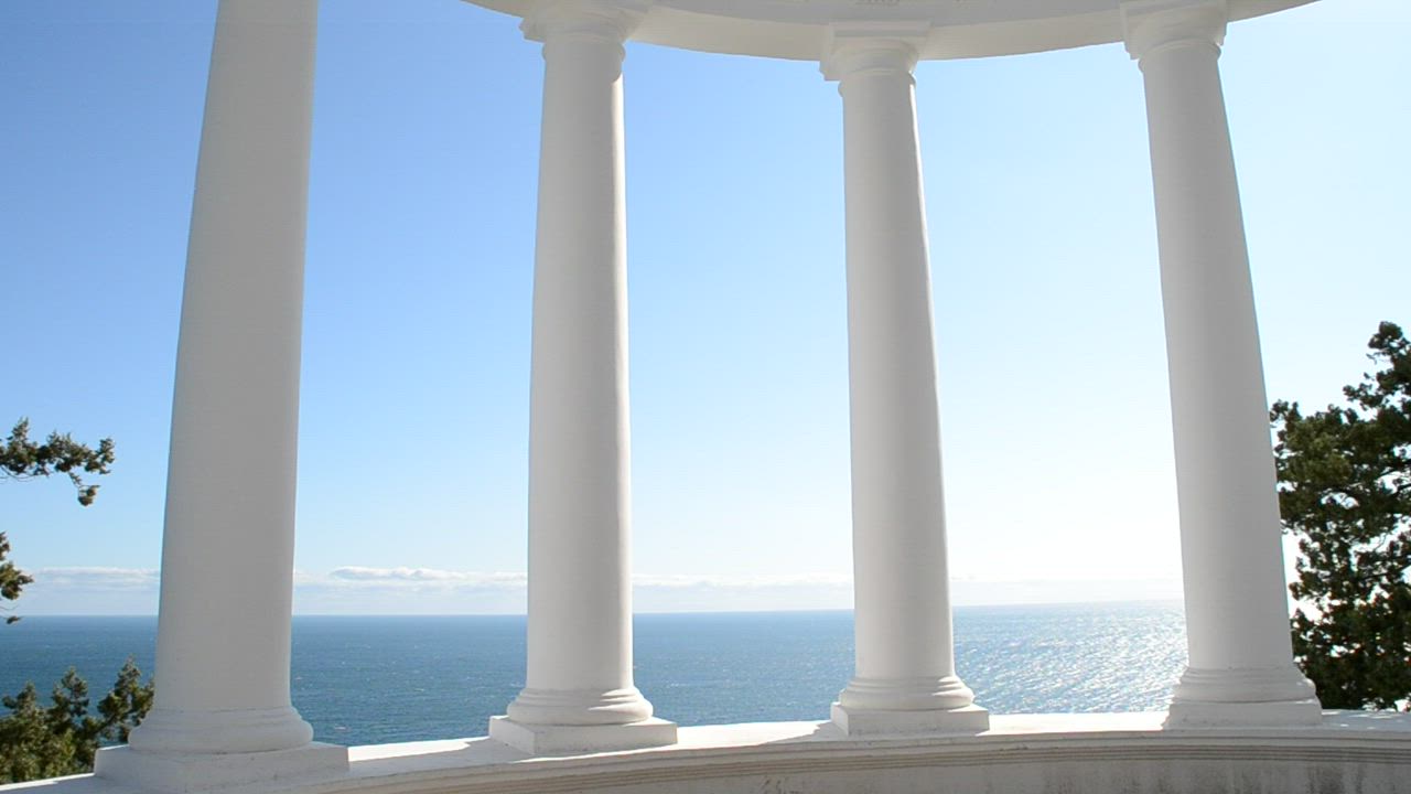 Clean white Columns against the ocean - Free Stock Video