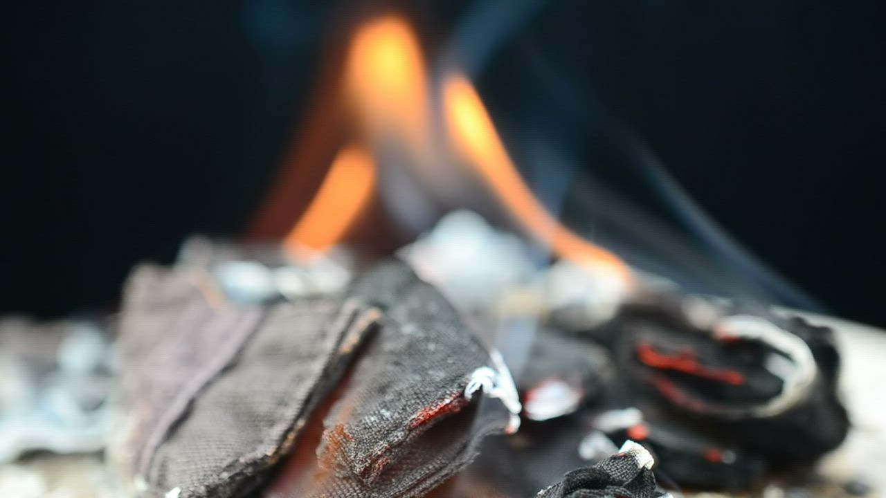 Fabric on fire in a dark room - Free Stock Video