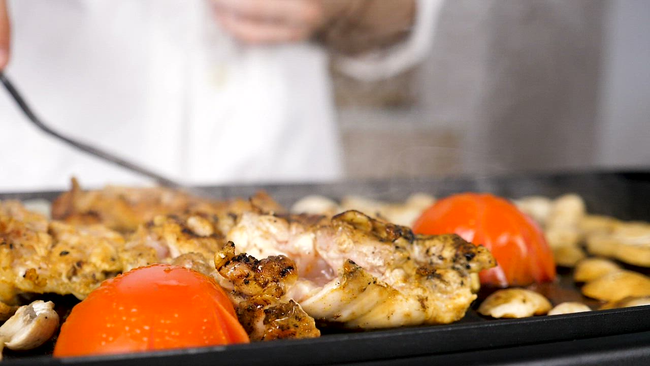 Cooking chicken on a flat grill - Free Stock Video