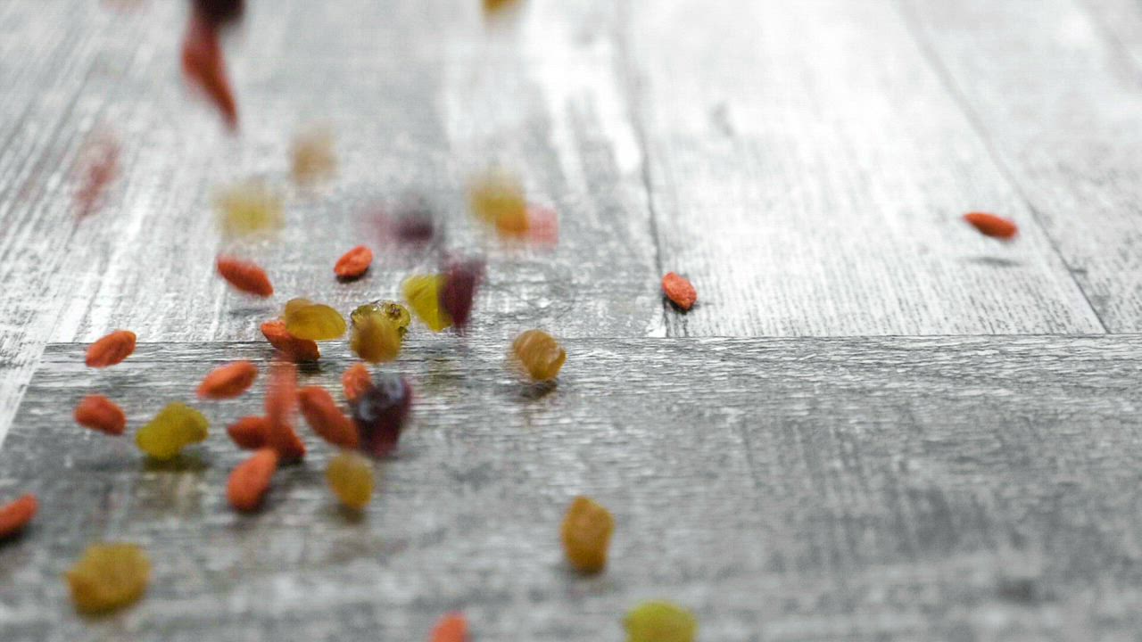 Dried fruit falling onto a table - Free Stock Video