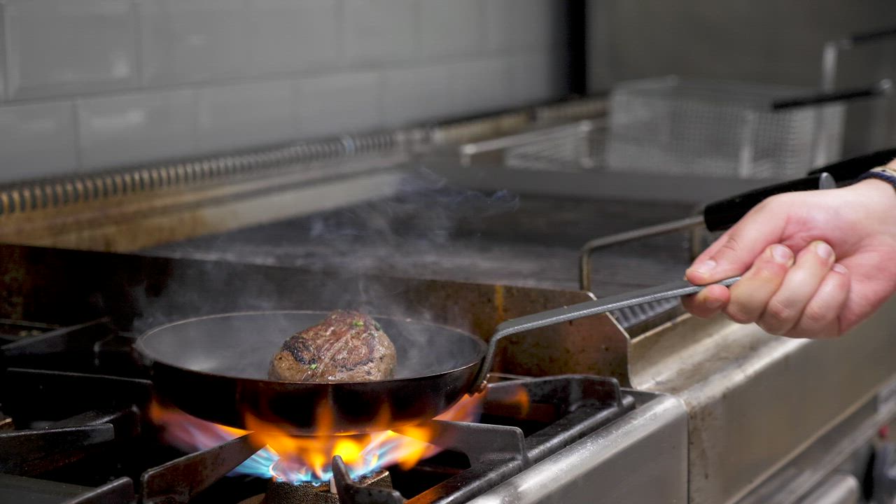 Frying beef in a kitchen - Free Stock Video