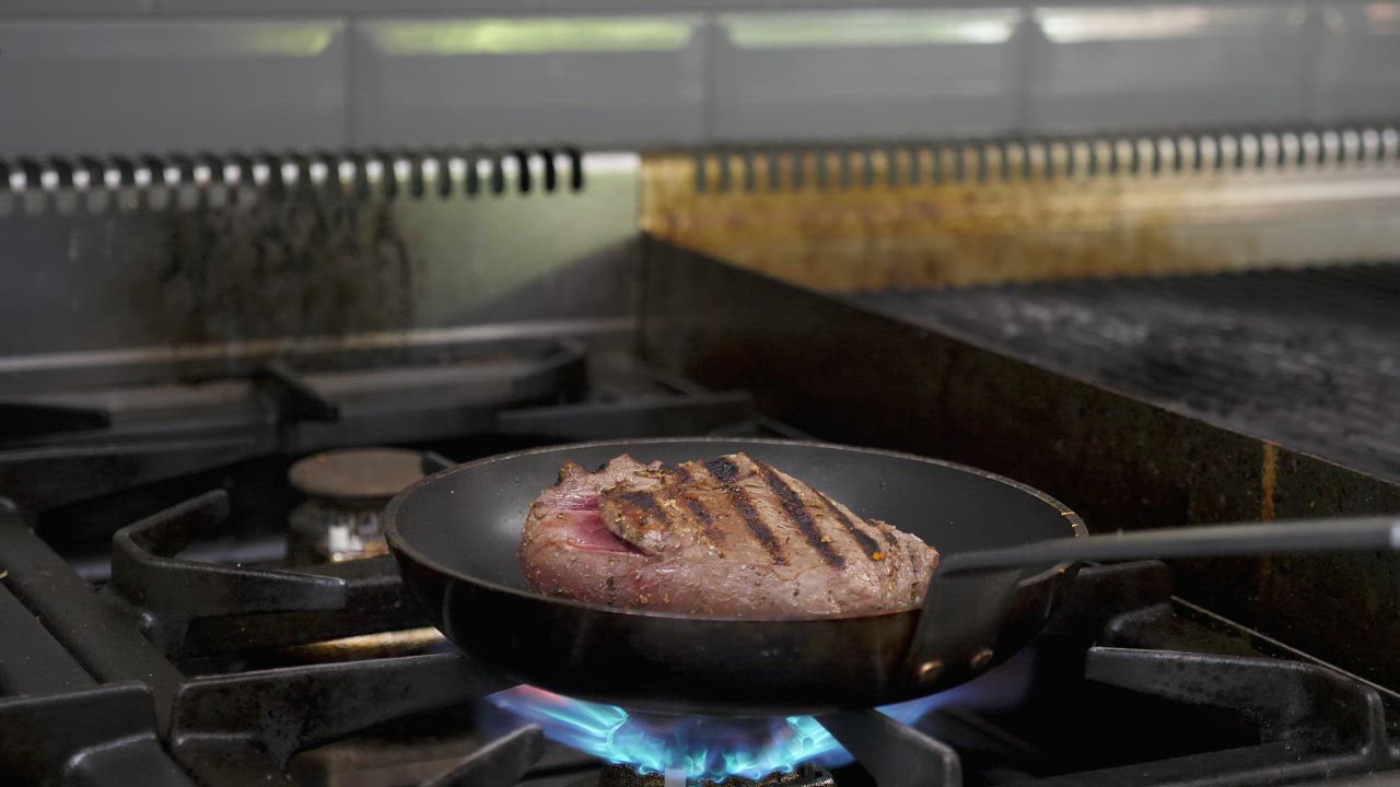Pouring oil over beef - Free Stock Video