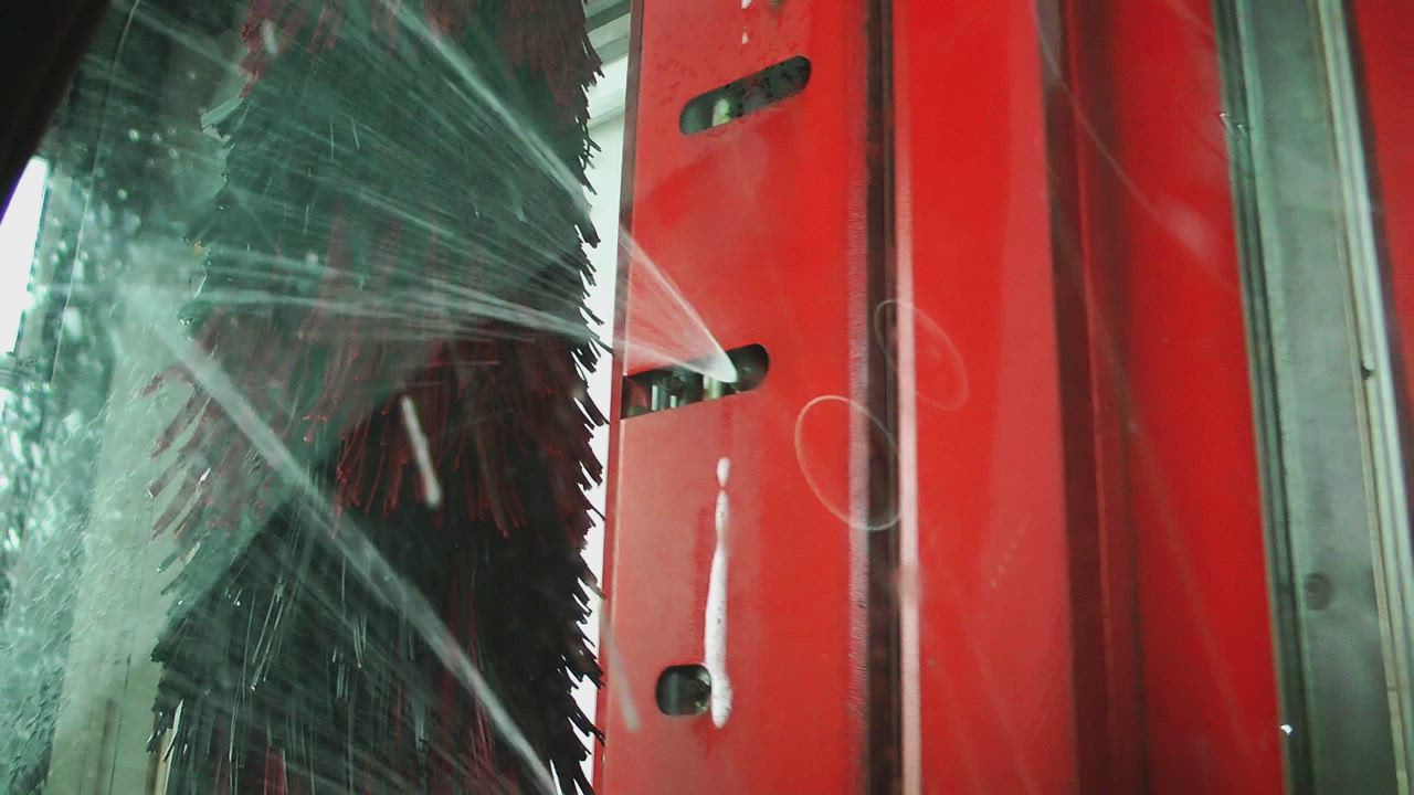 Car washer soaping the window viewed from inside - Free Stock Video