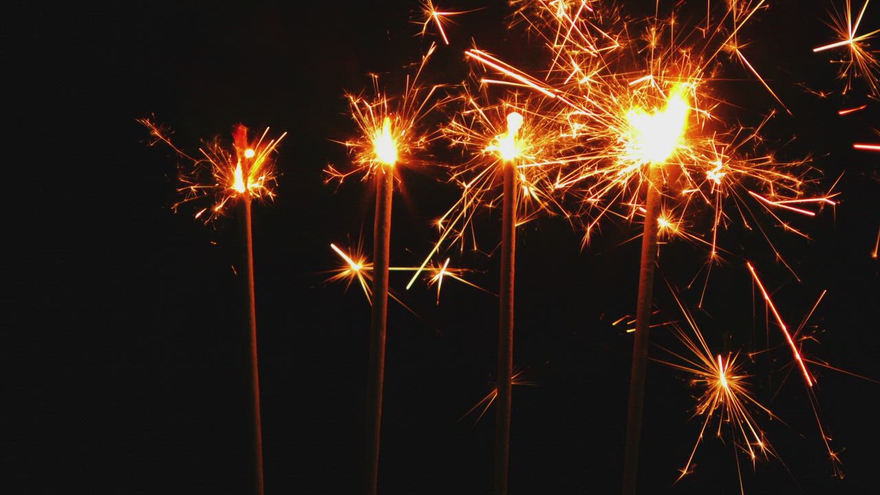 Four sparks lights burning in a dark place - Free Stock Video