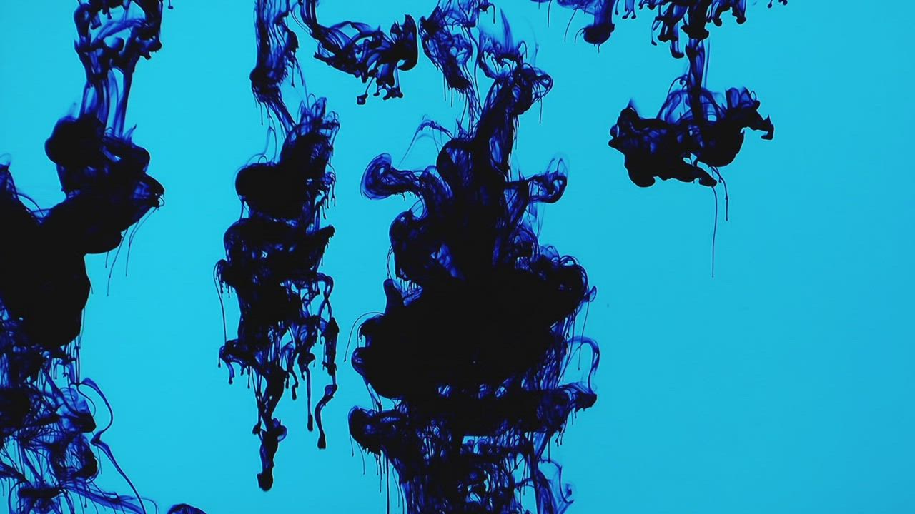 Drops of blue ink are immersed in water - Free Stock Video