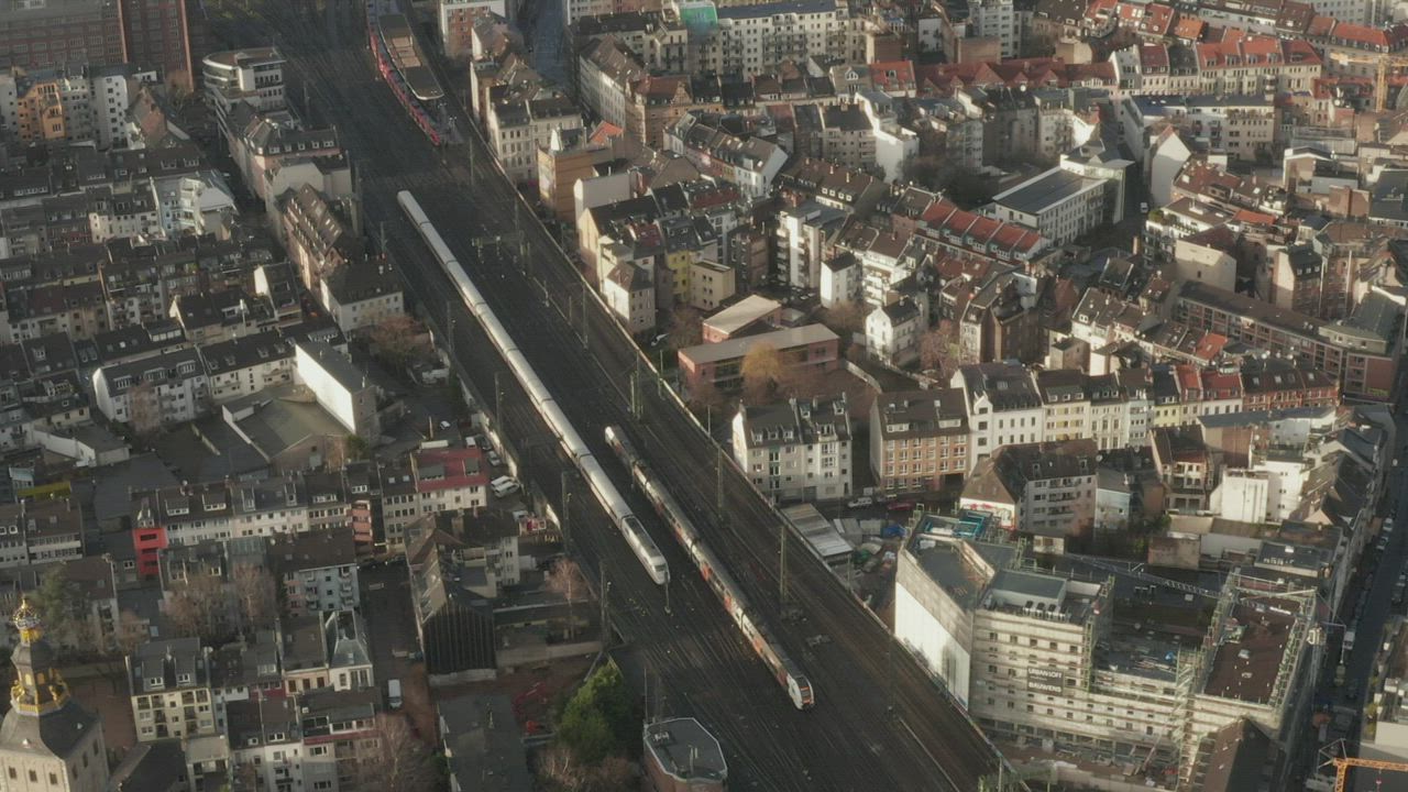 Passenger trains in the middle of a European city - Free Stock Video
