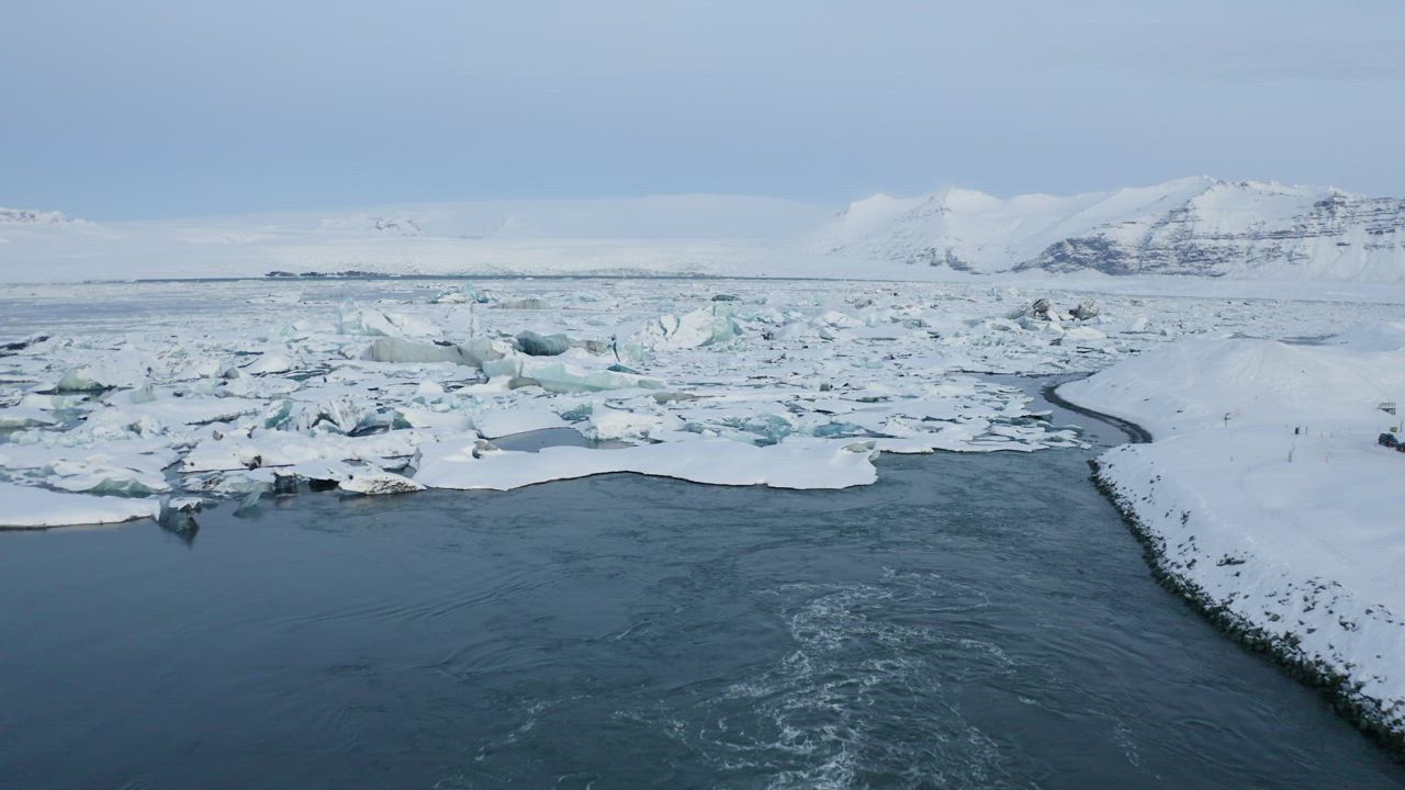Flying over a river full of big ice at Iceland - Free Stock Video