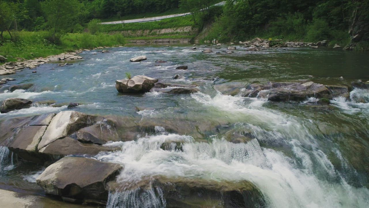Small waterfall in a river in nature, slow motion - Free Stock Video