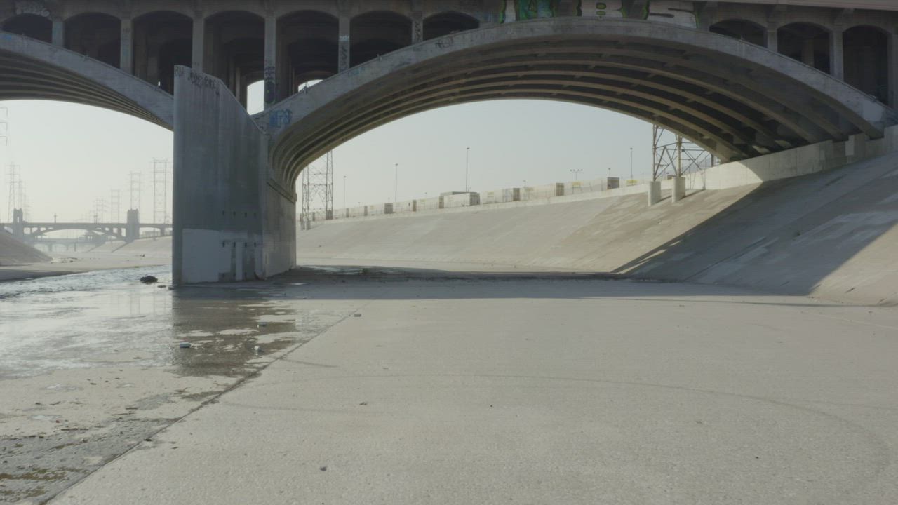Going under a bridge in a large drainage canal - Free Stock Video
