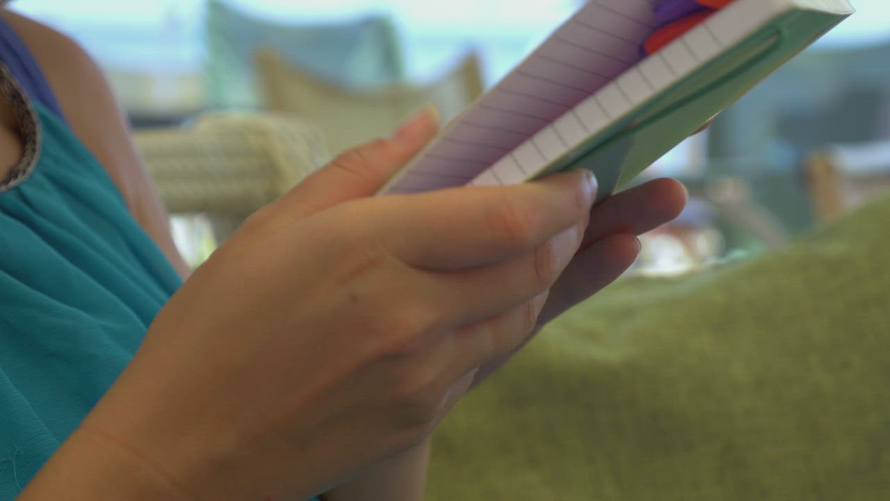 Writing in small notebook - Free Stock Video