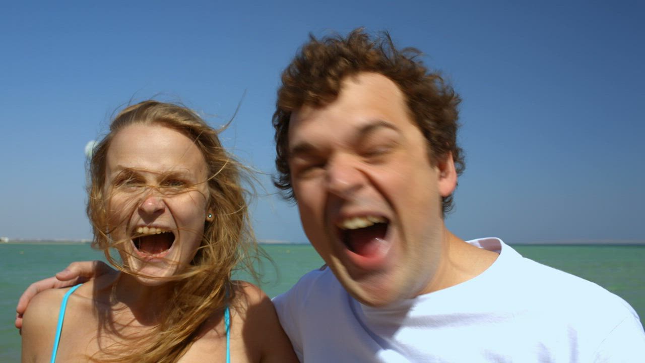 Couple making funny faces and kissing - Free Stock Video