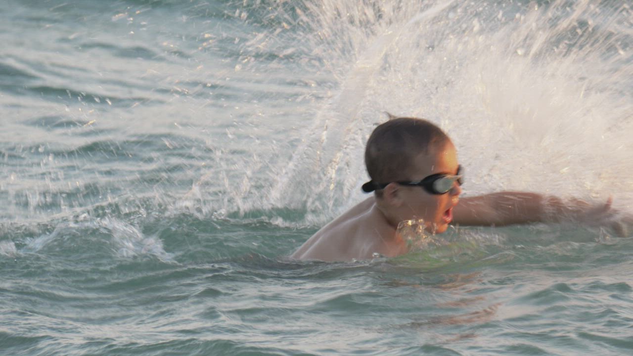 Splashing in the waves - Free Stock Video