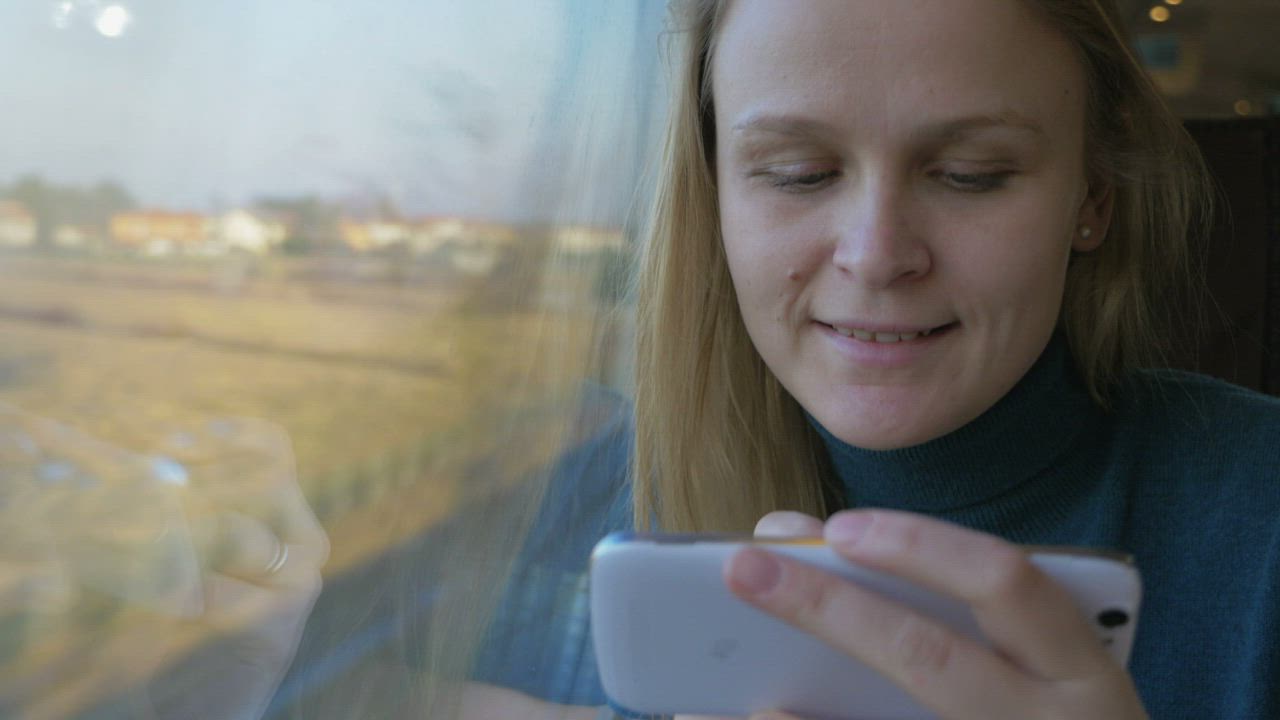 Woman smiles as she checks her messages - Free Stock Video
