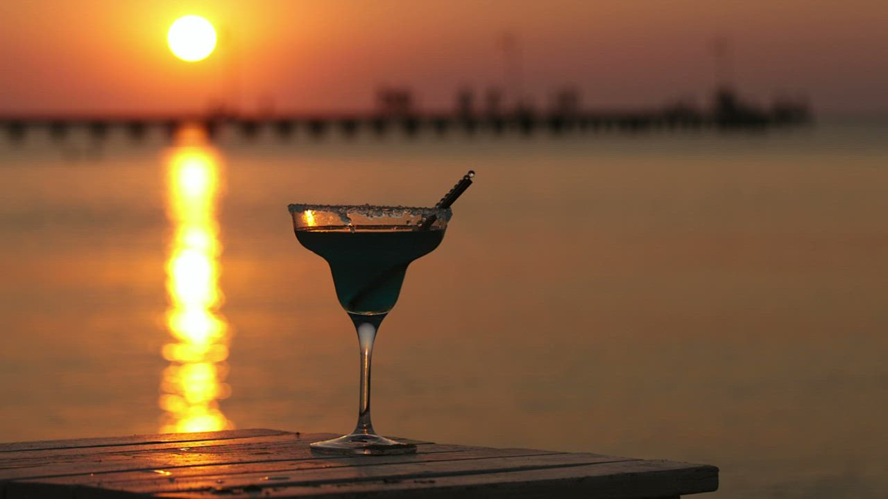 Tropical cocktail glass at sunset - Free Stock Video