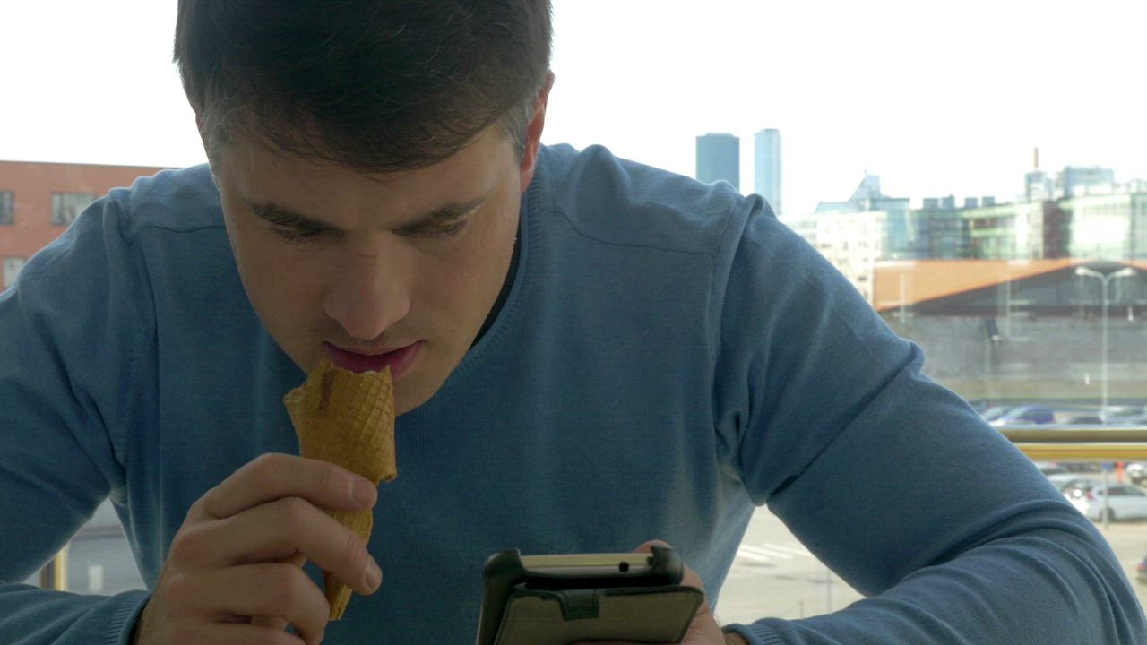 Texting while eating an ice cream - Free Stock Video