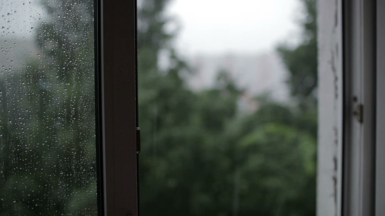 Heavy rain from an open window - Free Stock Video