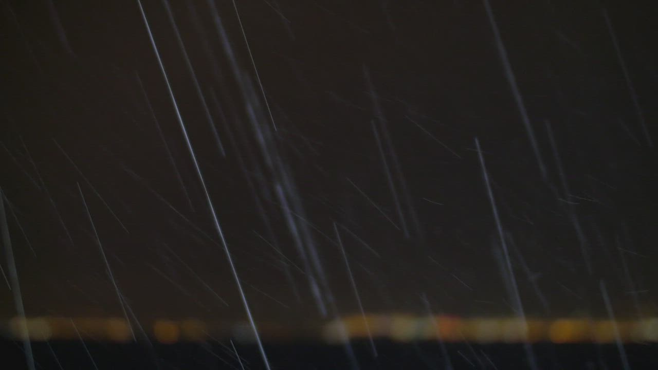 Heavy rain over the ocean at night - Free Stock Video