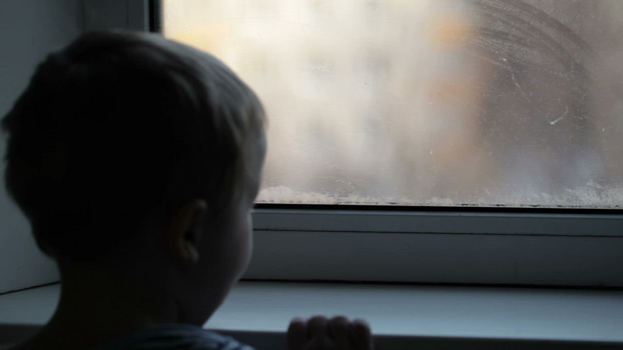 Boy looking through a misted window - Free Stock Video