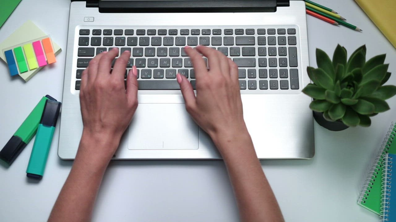 Woman typing on an English keyboard - Free Stock Video