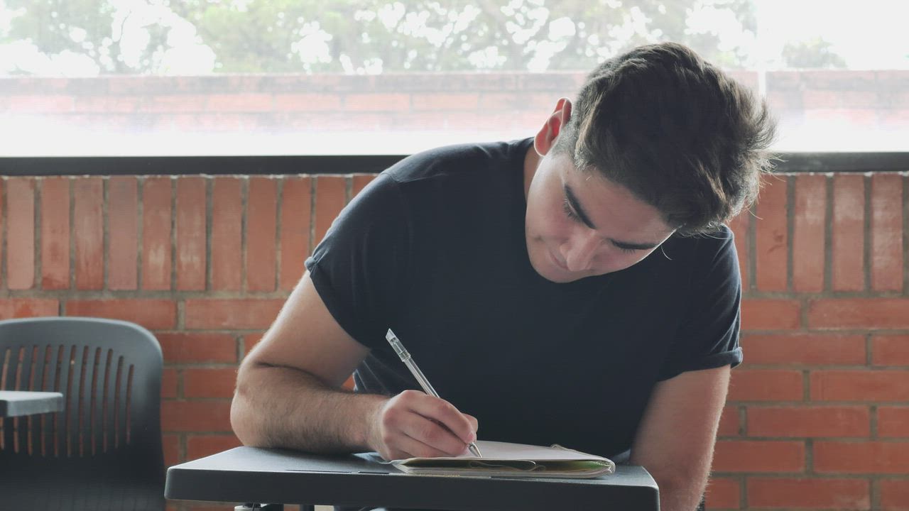 Young students copying the blackboard in a classroom - Free Stock Video
