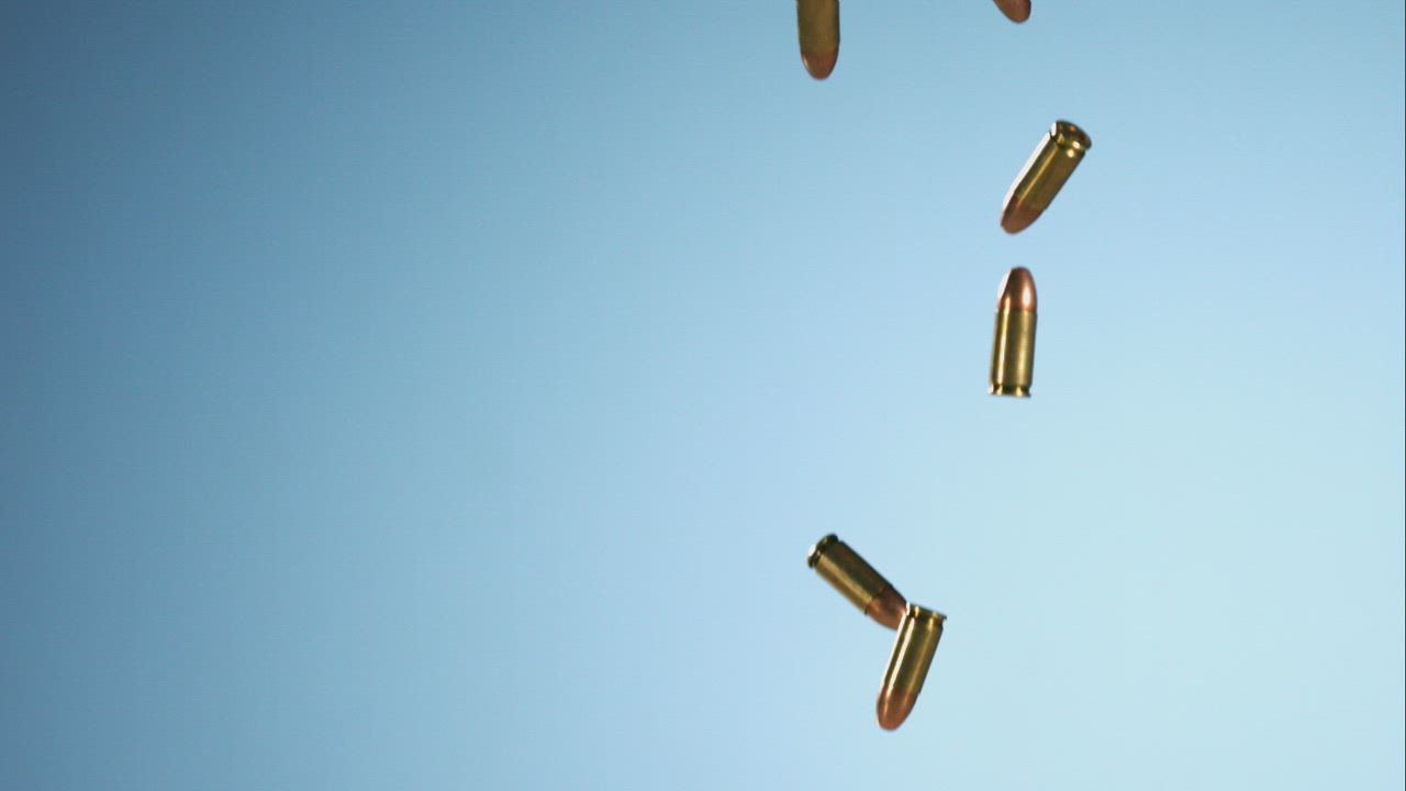 Falling bullets with blue background - Free Stock Video