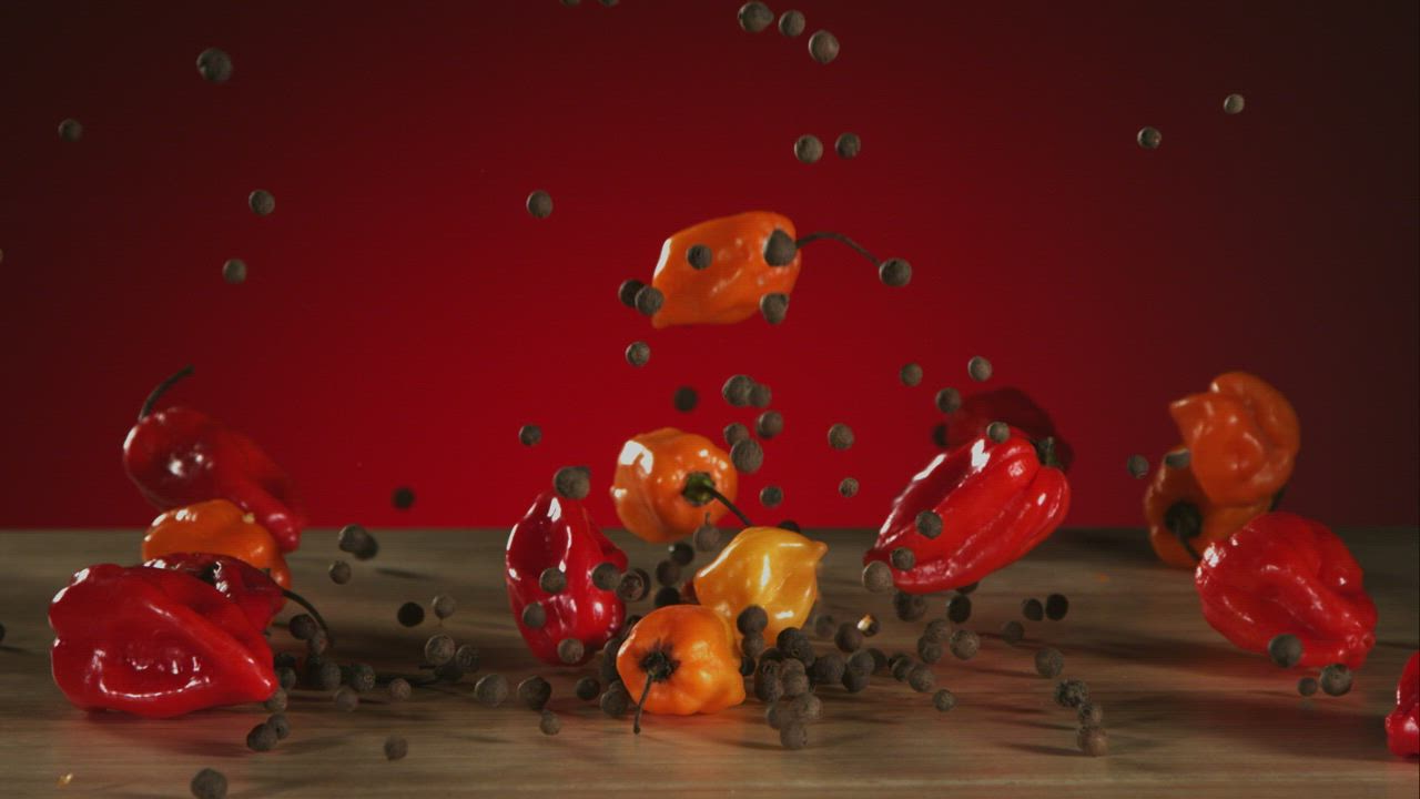 Mix of peppers falling to the table - Free Stock Video
