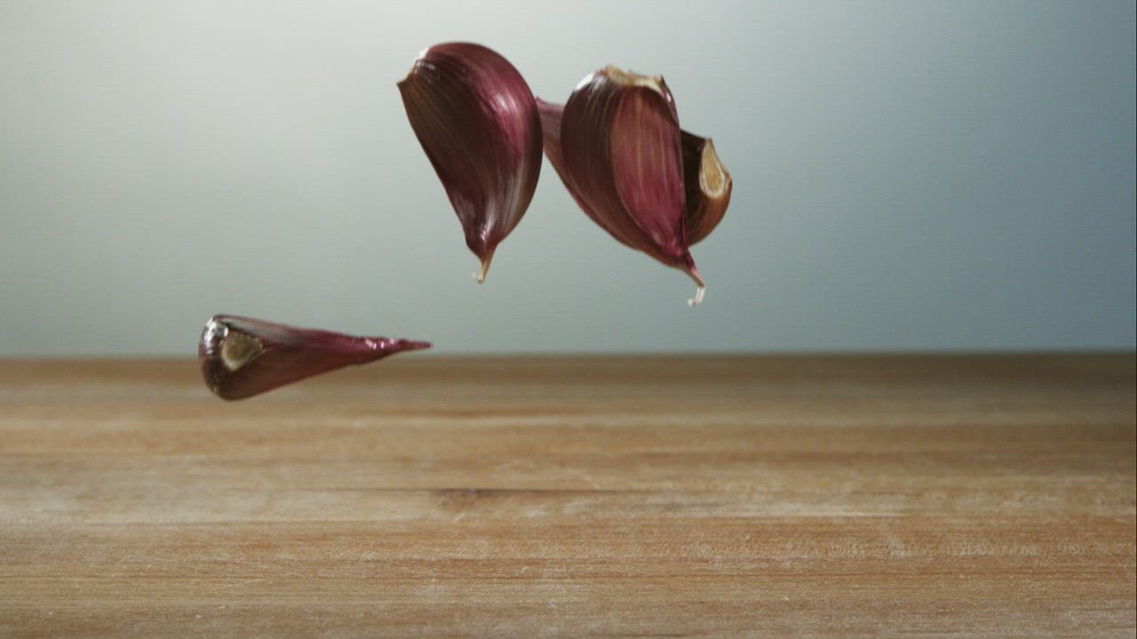 Garlic pieces falling to the table in slow motion - Free Stock Video