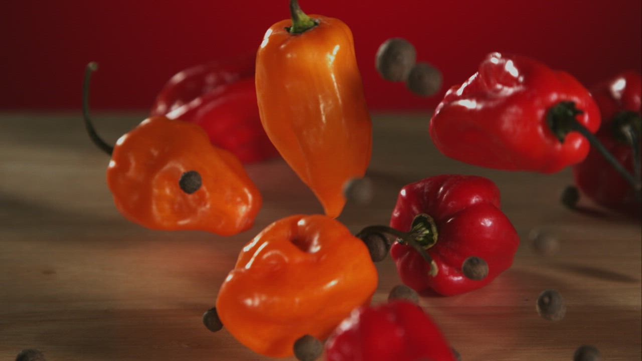 Peppers falling and bouncing into the table - Free Stock Video