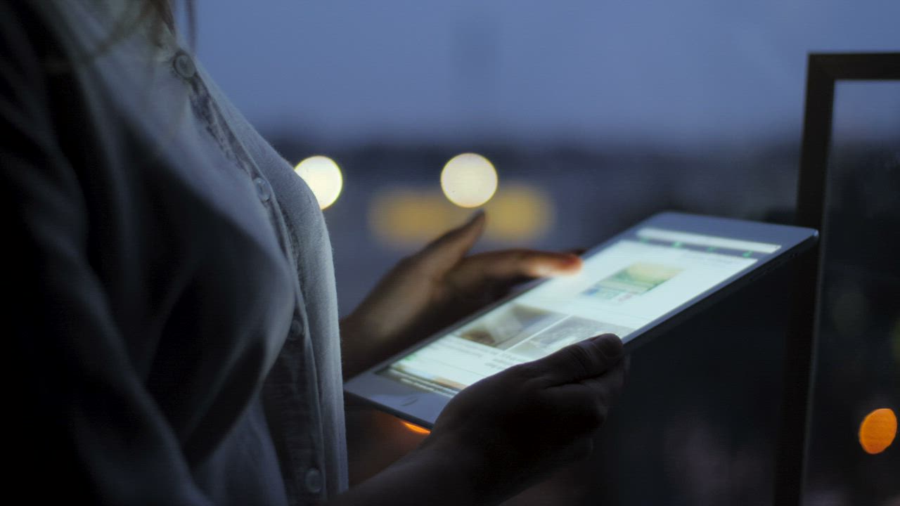 Woman scrolling the web on a tablet - Free Stock Video