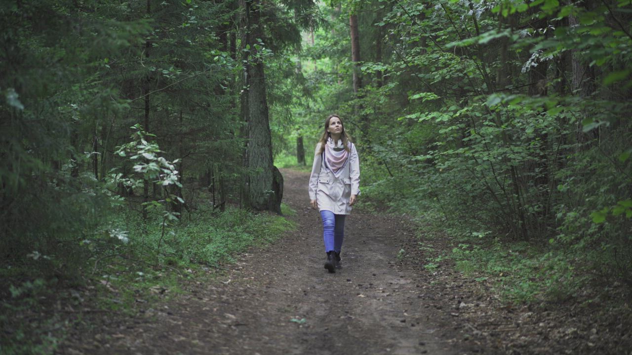 Young woman wandering in the forest - Free Stock Video