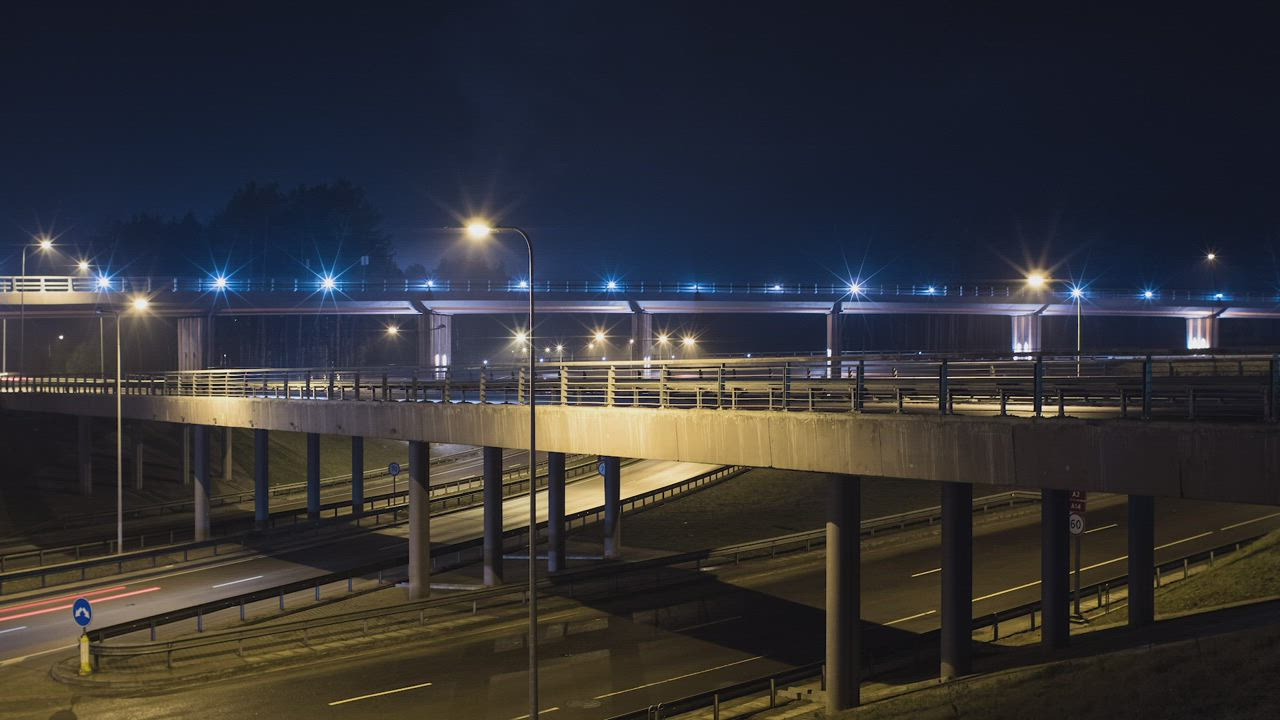Freeway and overpass fast traffic at night - Free Stock Video
