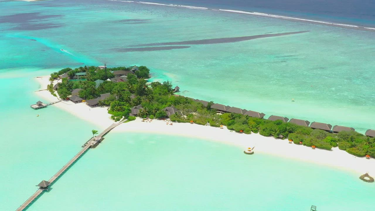 Small island surrounded by turquoise sea - Free Stock Video