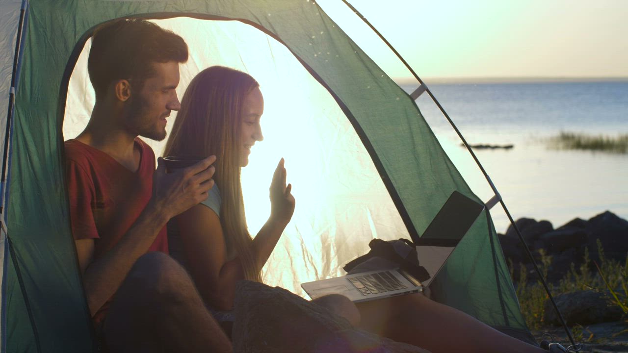 Couple having a video call while camping - Free Stock Video
