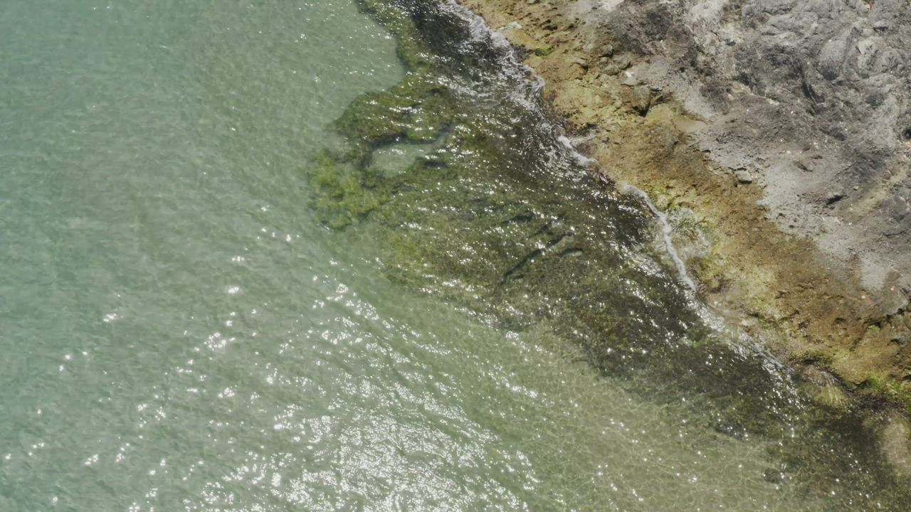 Clear water below the cliffs - Free Stock Video