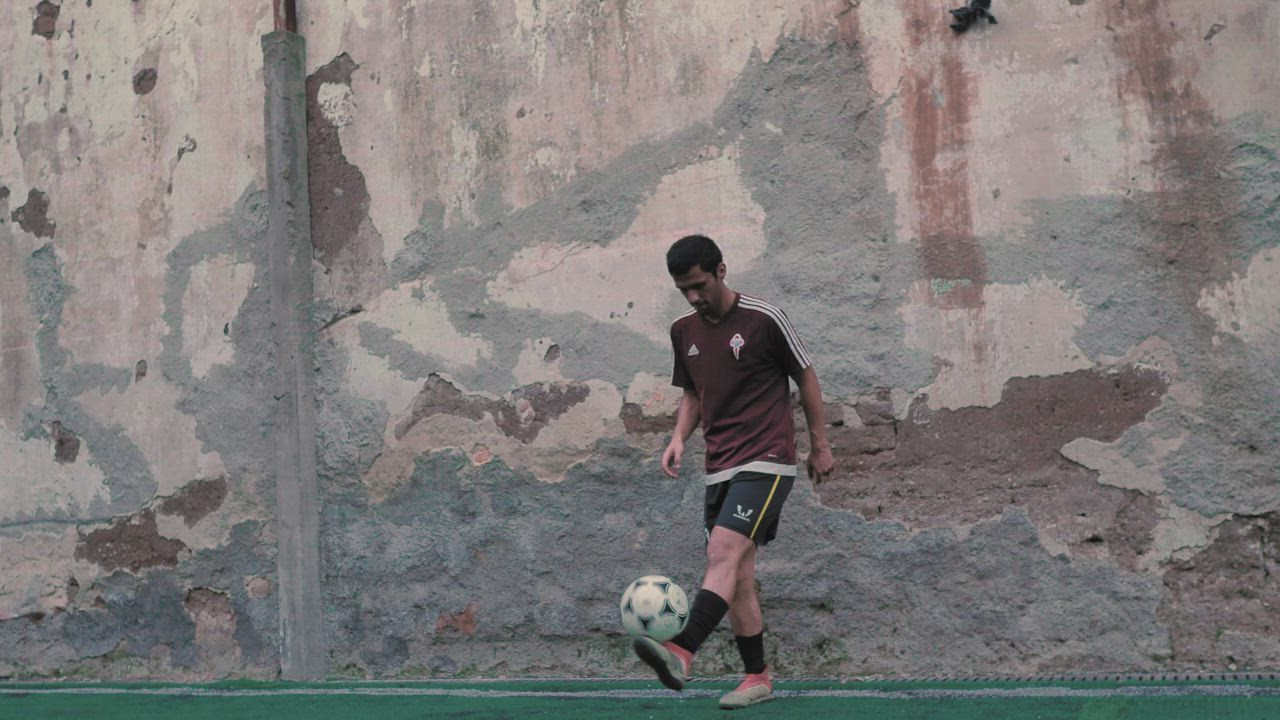 Street football players practicing crosses and shots - Free Stock Video