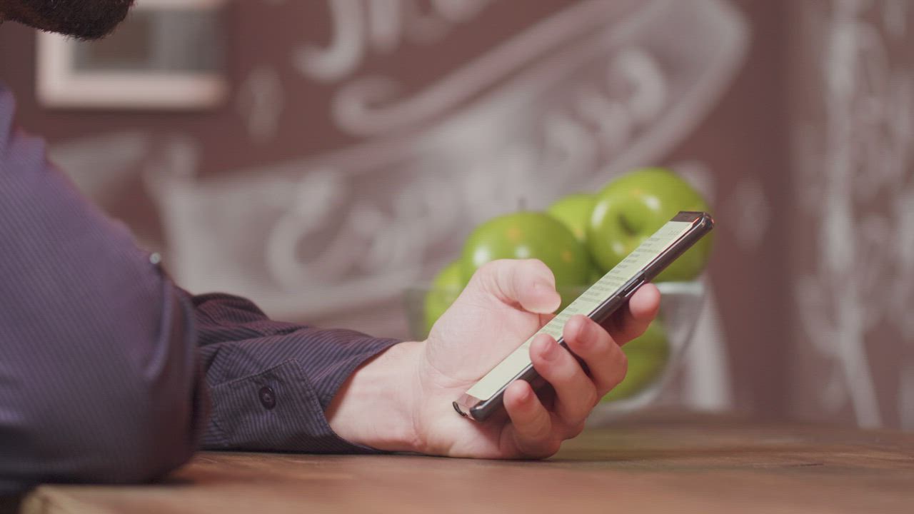 Man scrolling through his cellphone - Free Stock Video