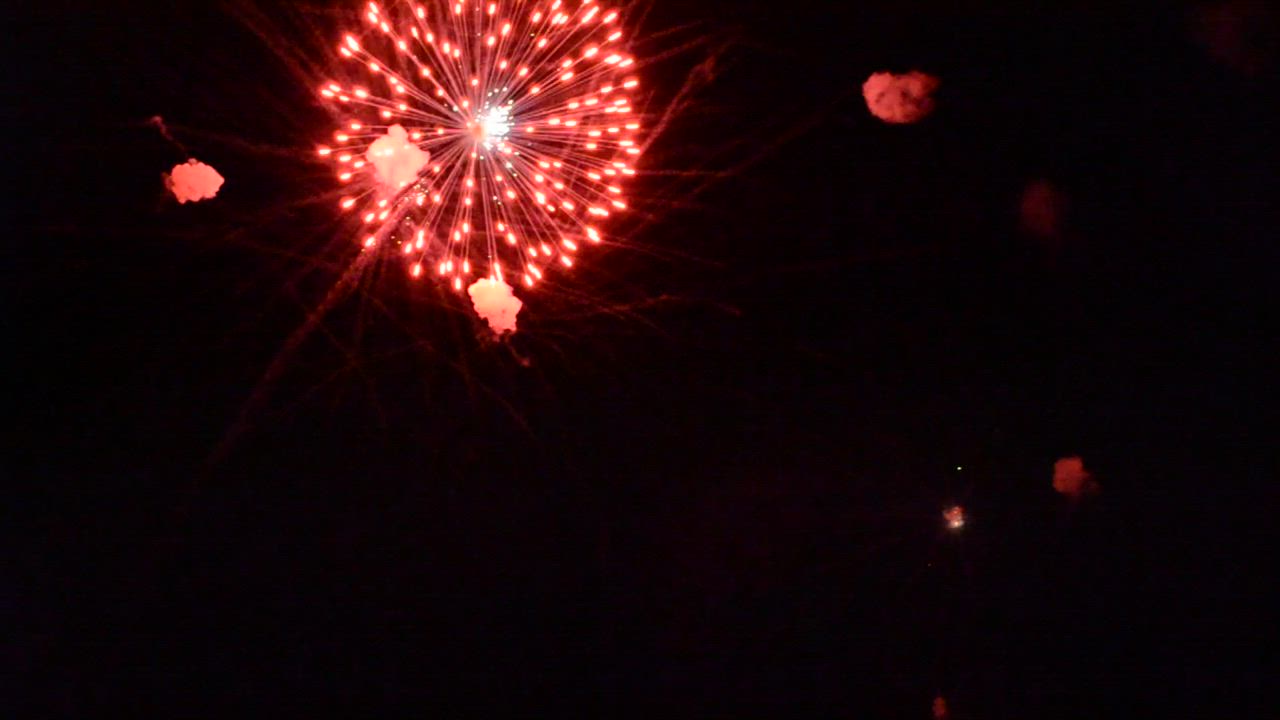 Red fireworks above the town - Free Stock Video