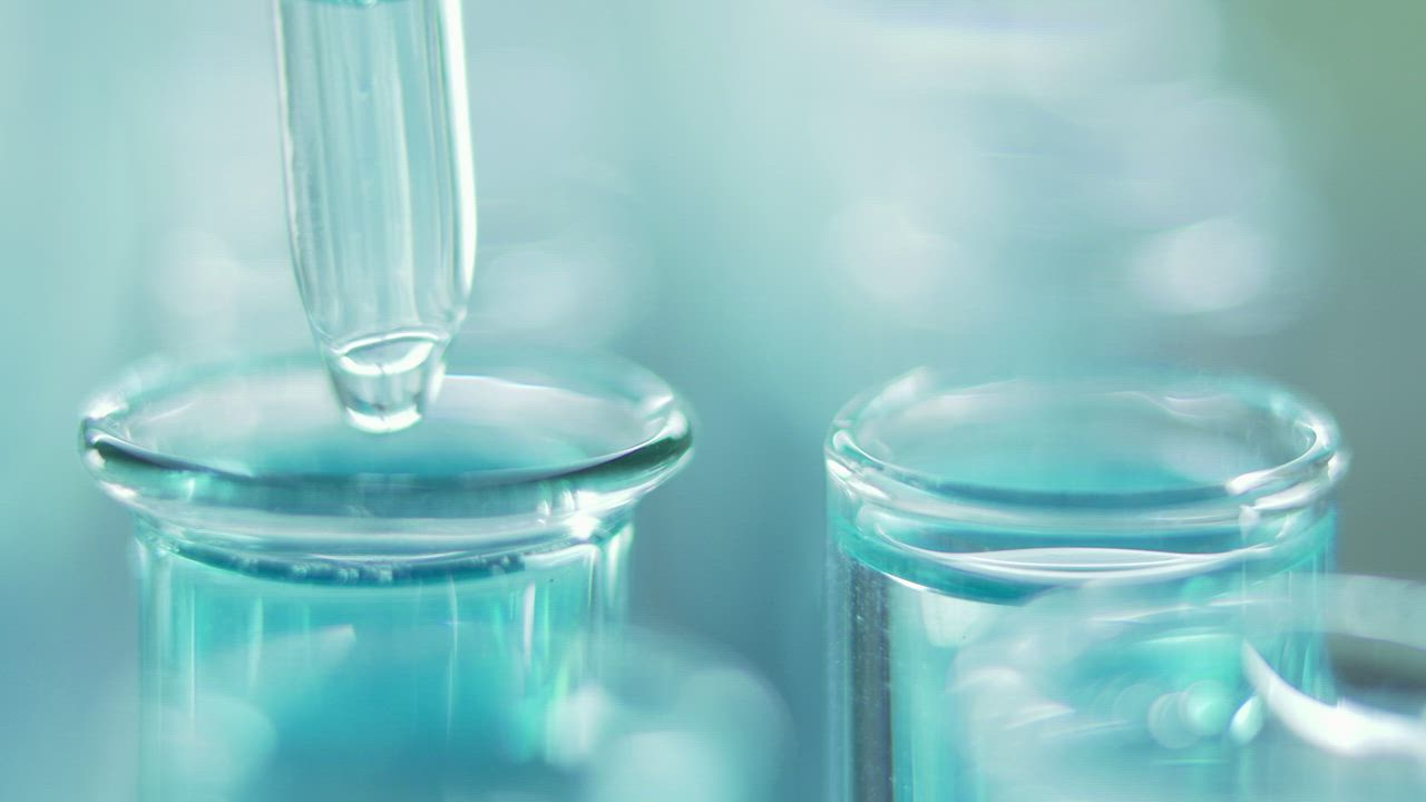 Dropping water on a laboratory tube - Free Stock Video