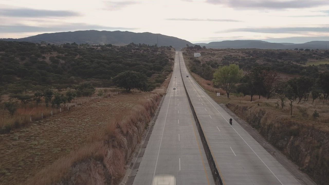 Aerial view of biker riding a motorcycle - Free Stock Video