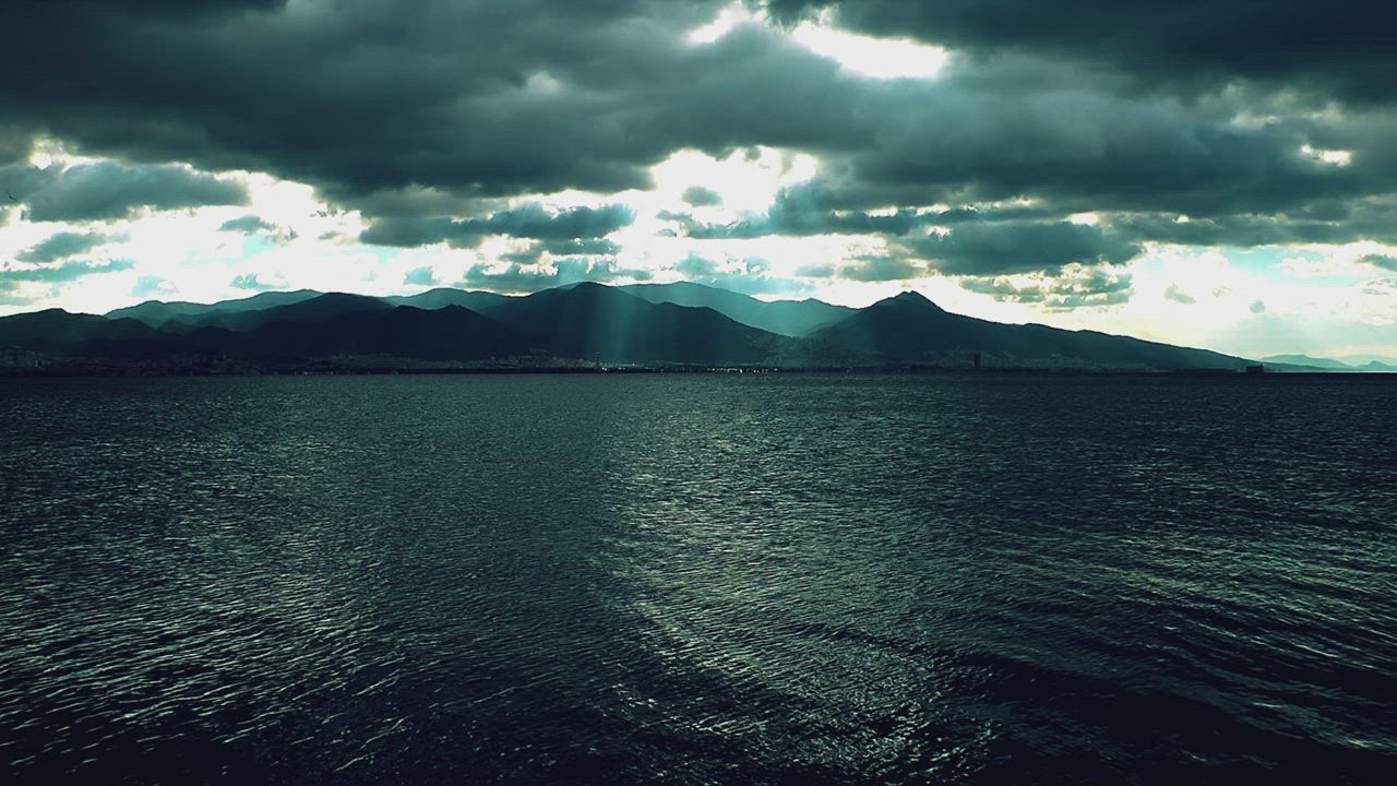 Dark landscape of a calm sea and a cloudy sky - Free Stock Video