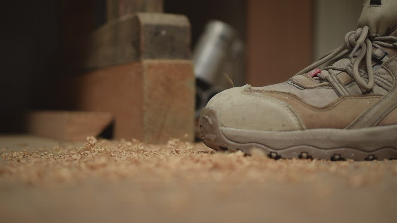 Sawdust falling on a carpenter's feet - Free Stock Video
