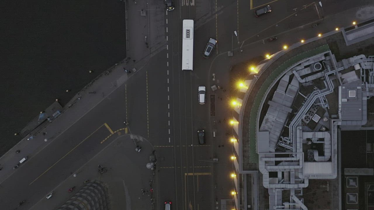 Urban passenger bus on an avenue next to the train - Free Stock Video