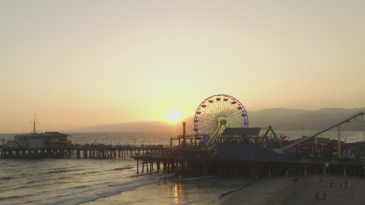Amusement park by the sea at sunset - Free Stock Video