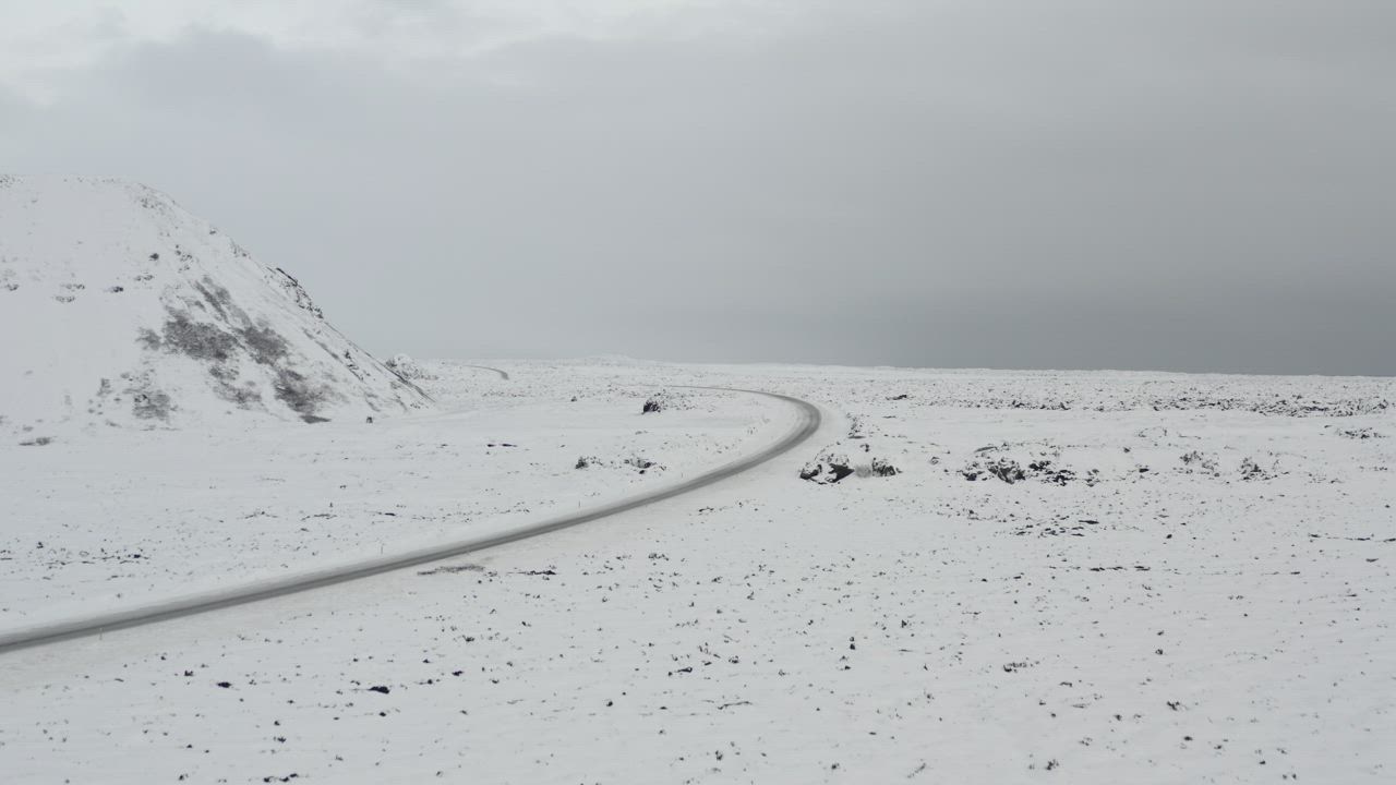 Road crossing a snowy landscape - Free Stock Video